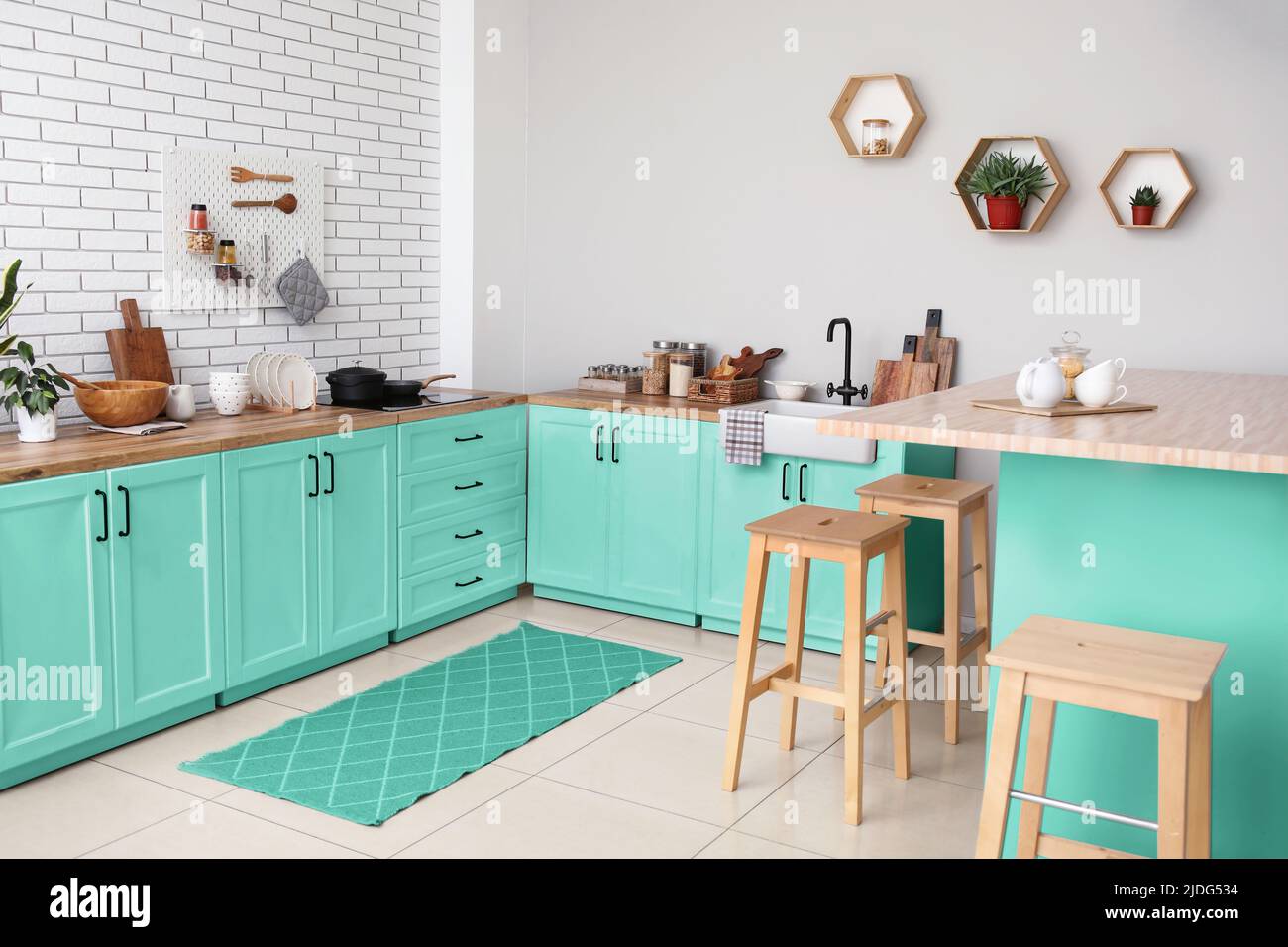Interior of light kitchen with mint furniture Stock Photo - Alamy