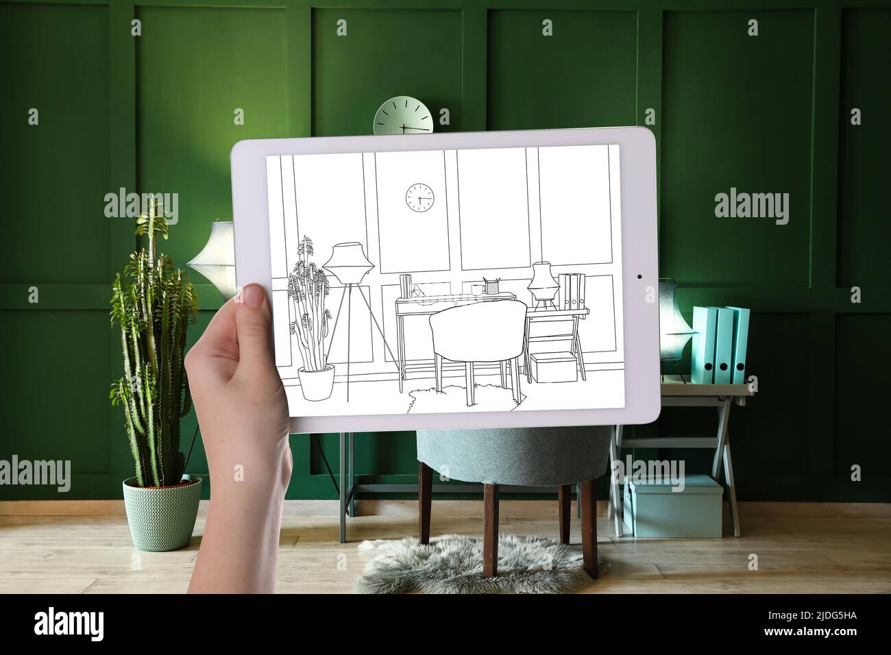 Designer holding tablet computer with drawing of new office interior ...