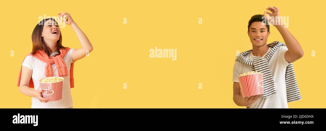 Happy people eating popcorn on yellow background with space for text ...