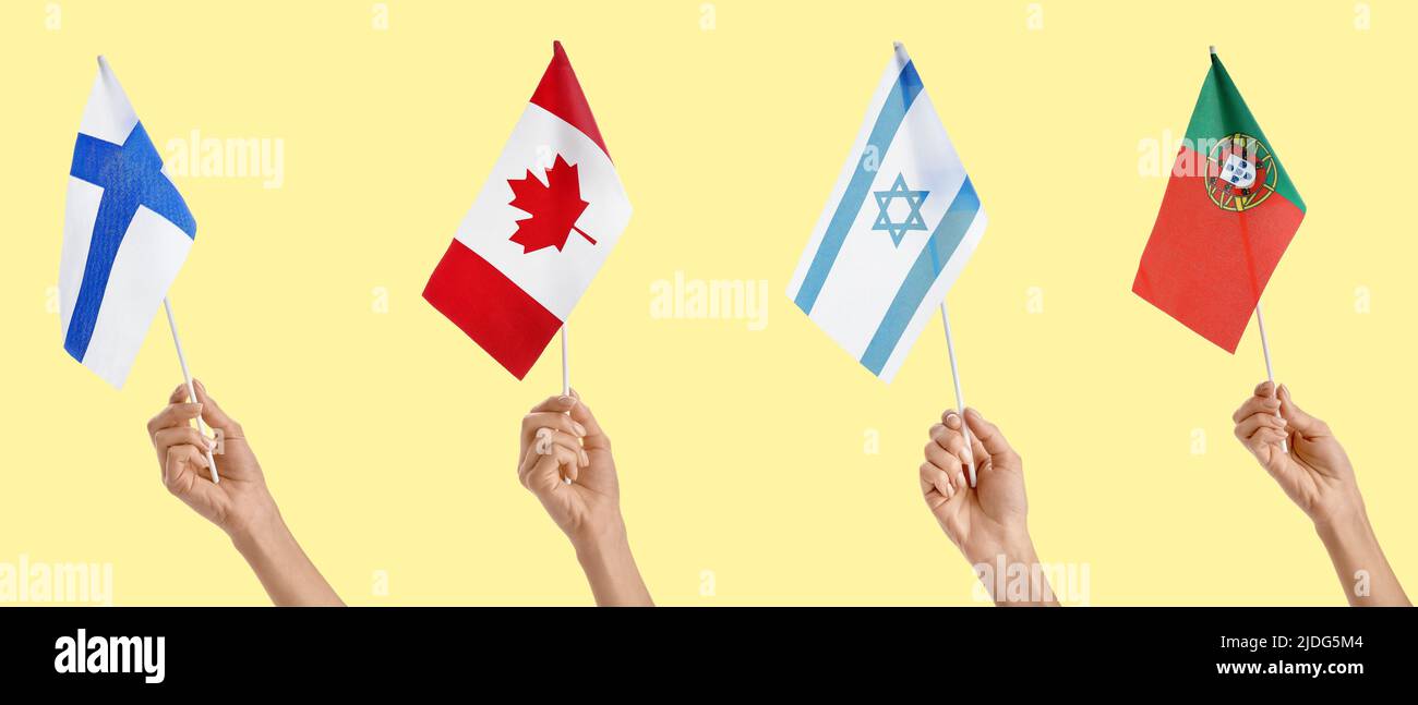 Hands with flags of different countries on yellow background Stock ...