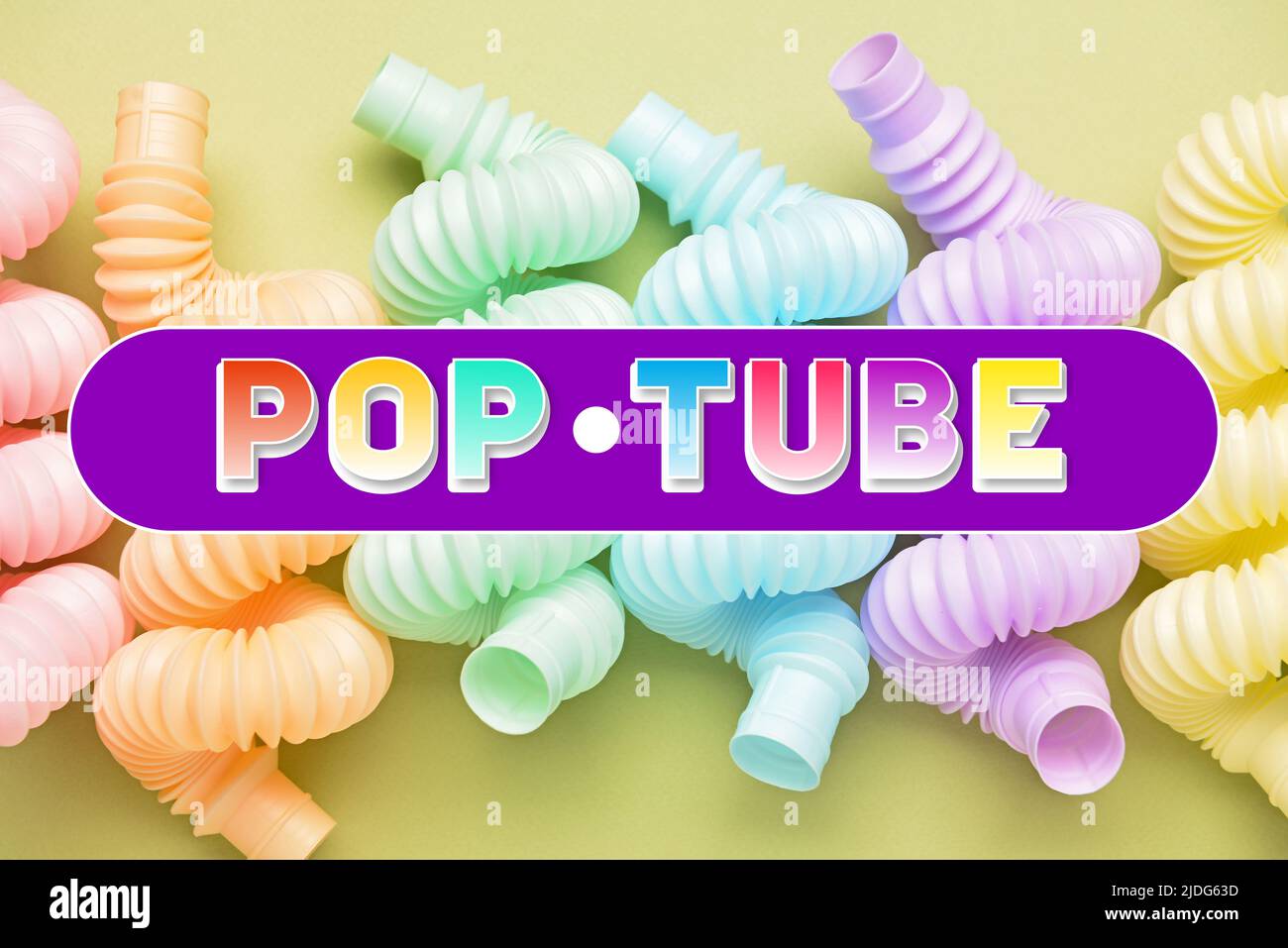 Different colorful Pop Tubes on yellow background Stock Photo - Alamy
