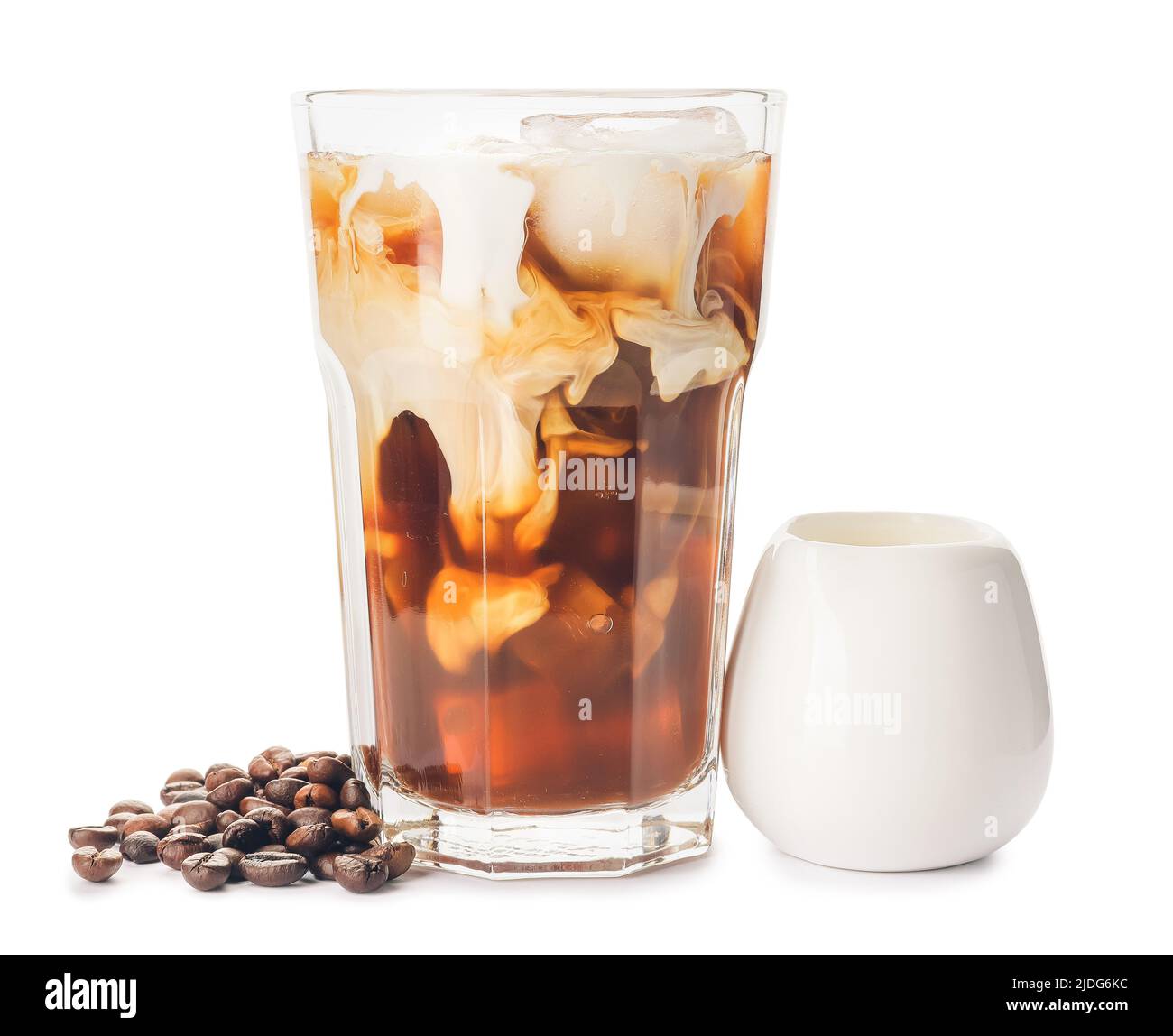 Glass of cold brew, coffee beans and milk on white background Stock ...
