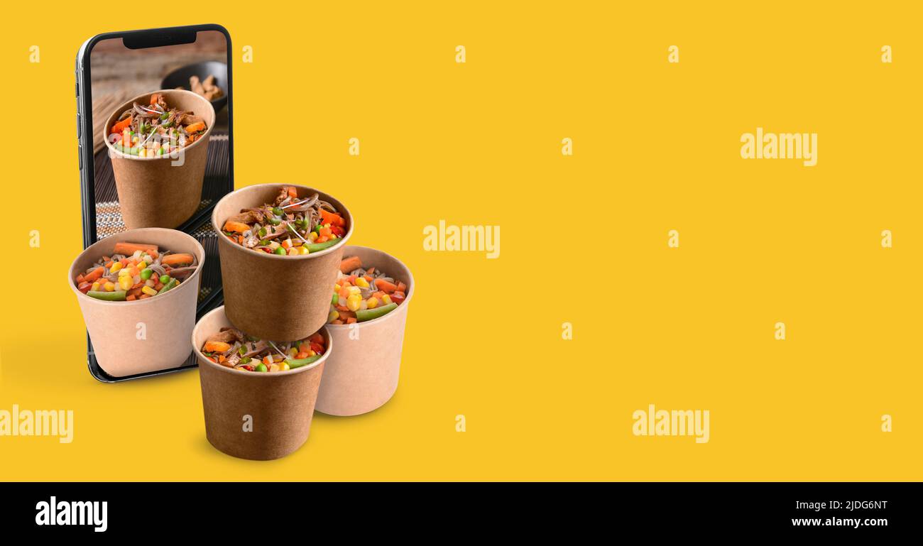 Modern mobile phone and many bowls with tasty Chinese noodles on yellow ...