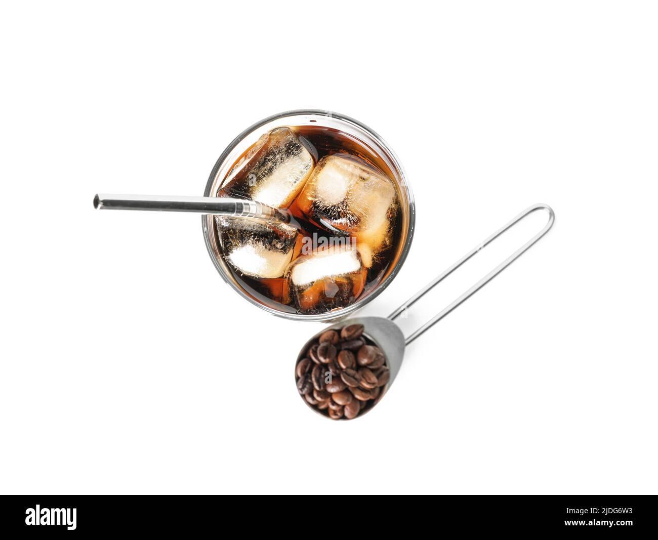 Glass of cold brew with straw and spoon with coffee beans on white ...