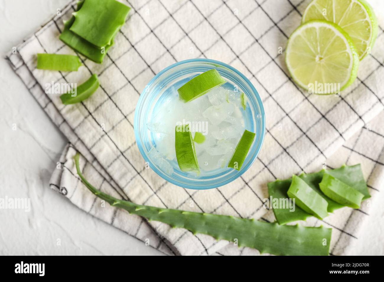 Glass of aloe juice with lime on white background Stock Photo - Alamy