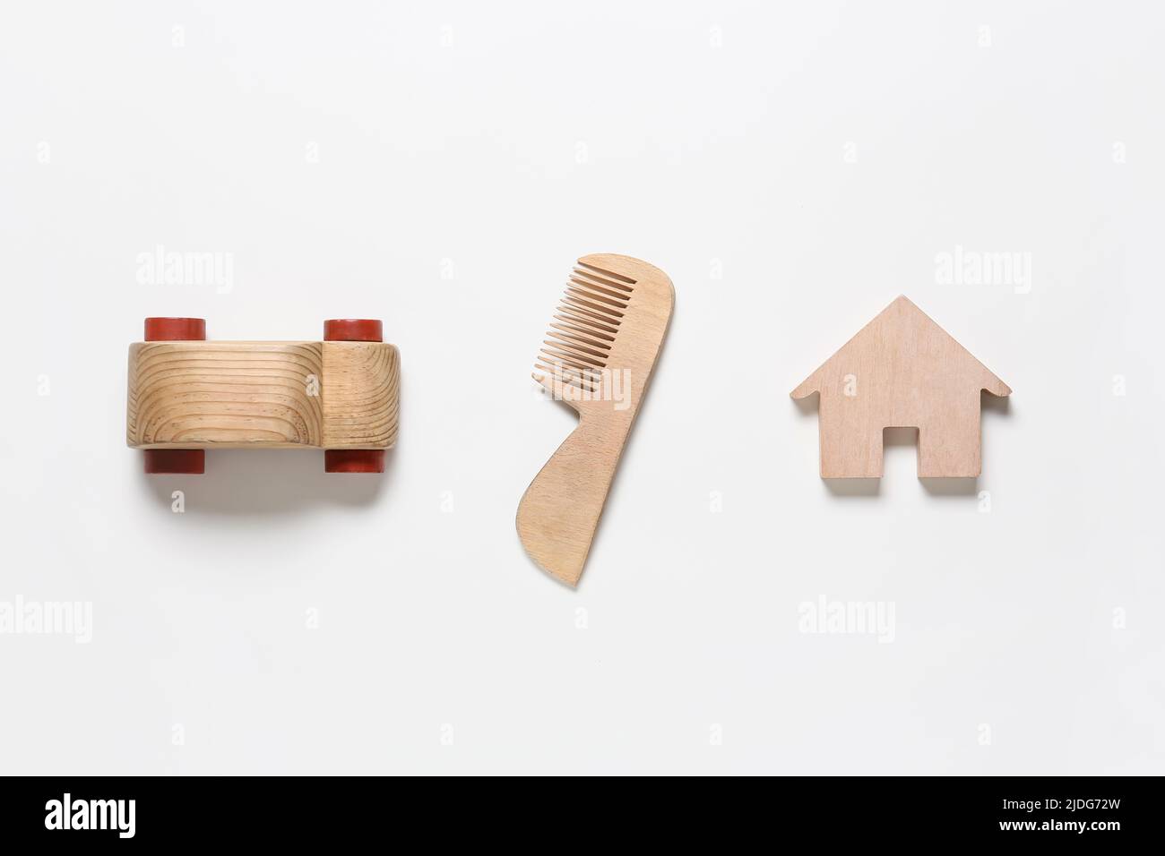 Wooden hair comb and baby toys on white background Stock Photo - Alamy