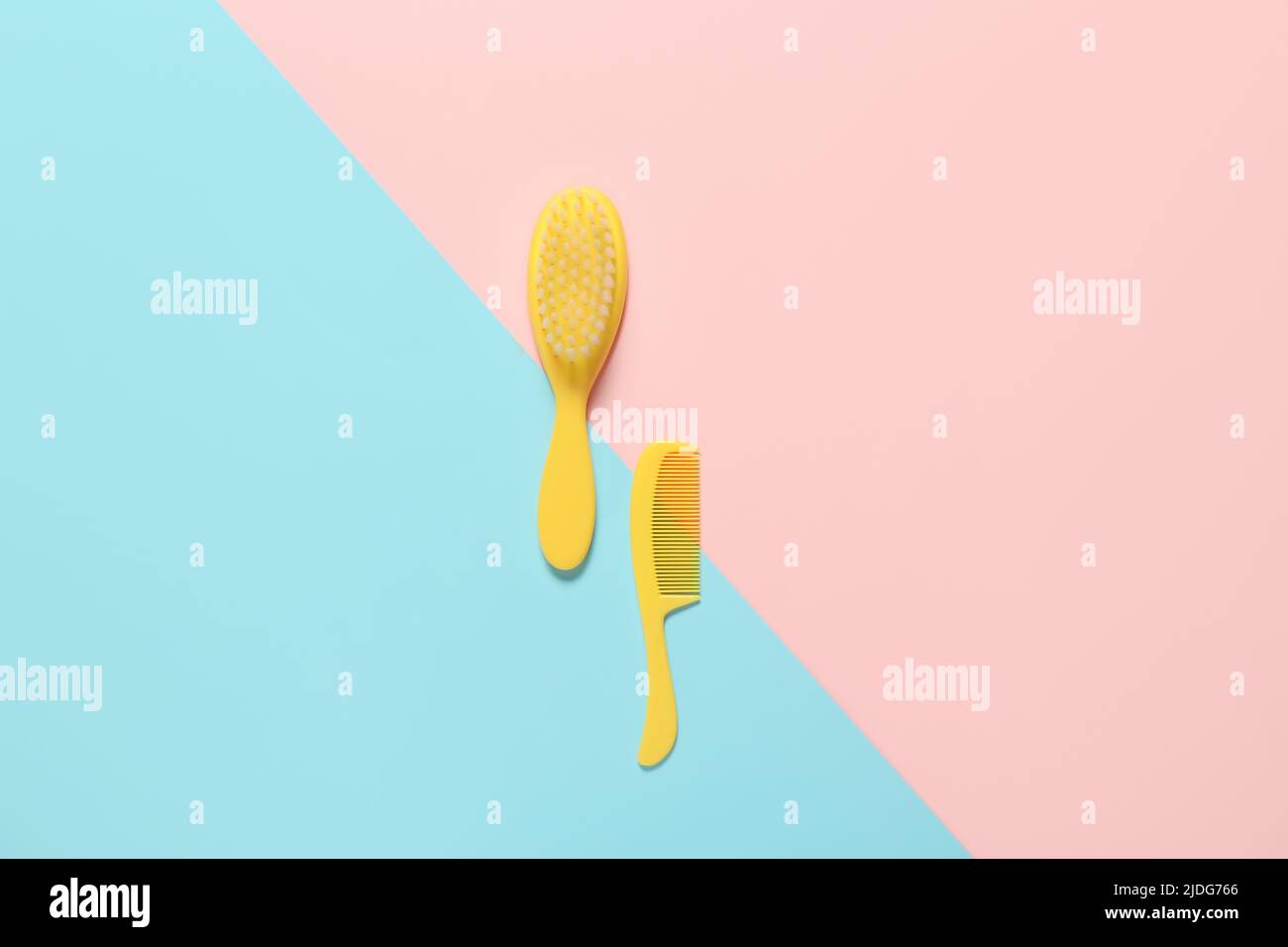 Hair brush and comb for baby on color background Stock Photo - Alamy