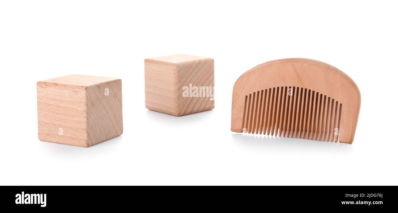 Wooden cubes and hair comb for baby on white background Stock Photo - Alamy