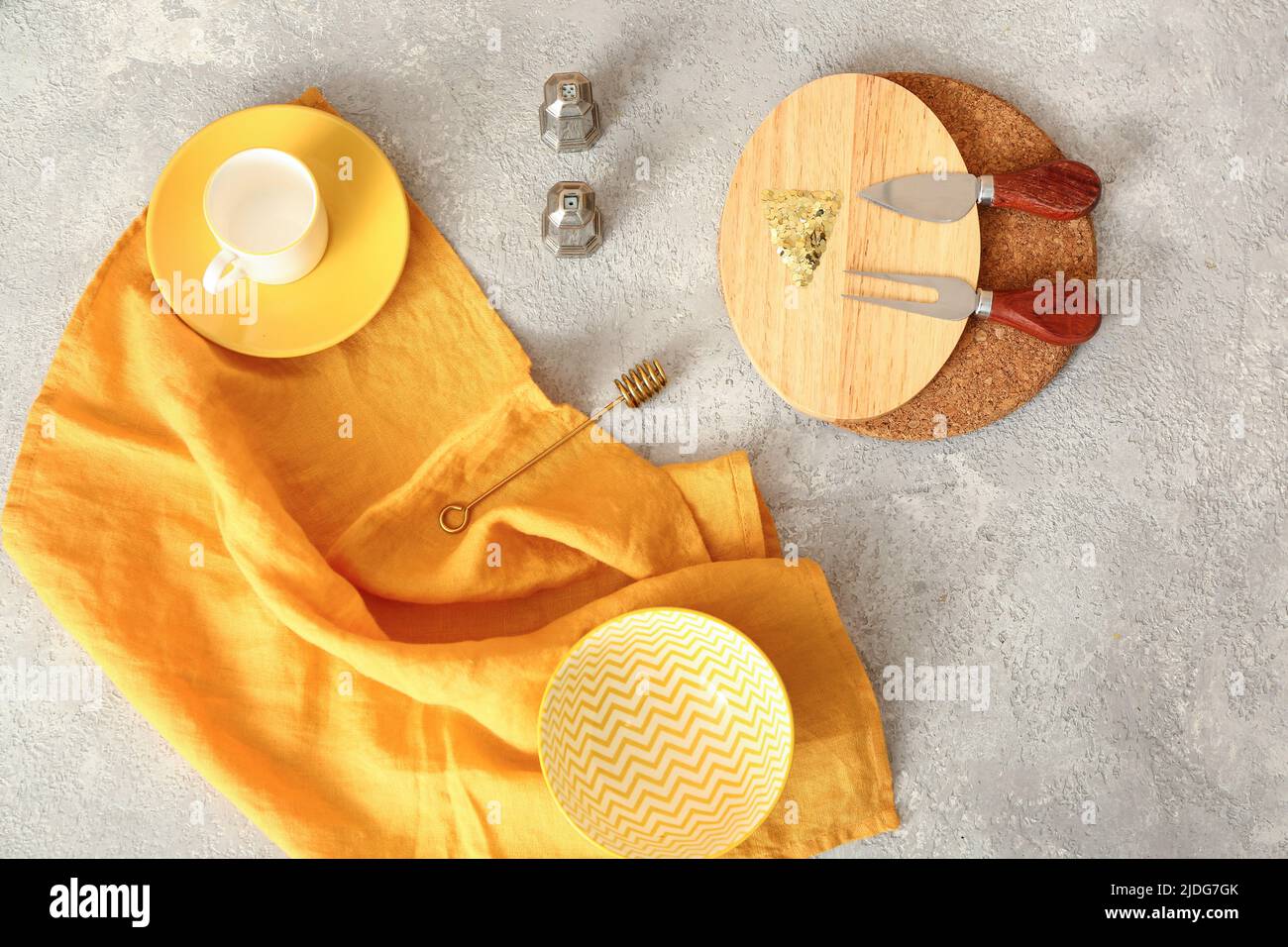 Yellow table setting on grey background Stock Photo - Alamy