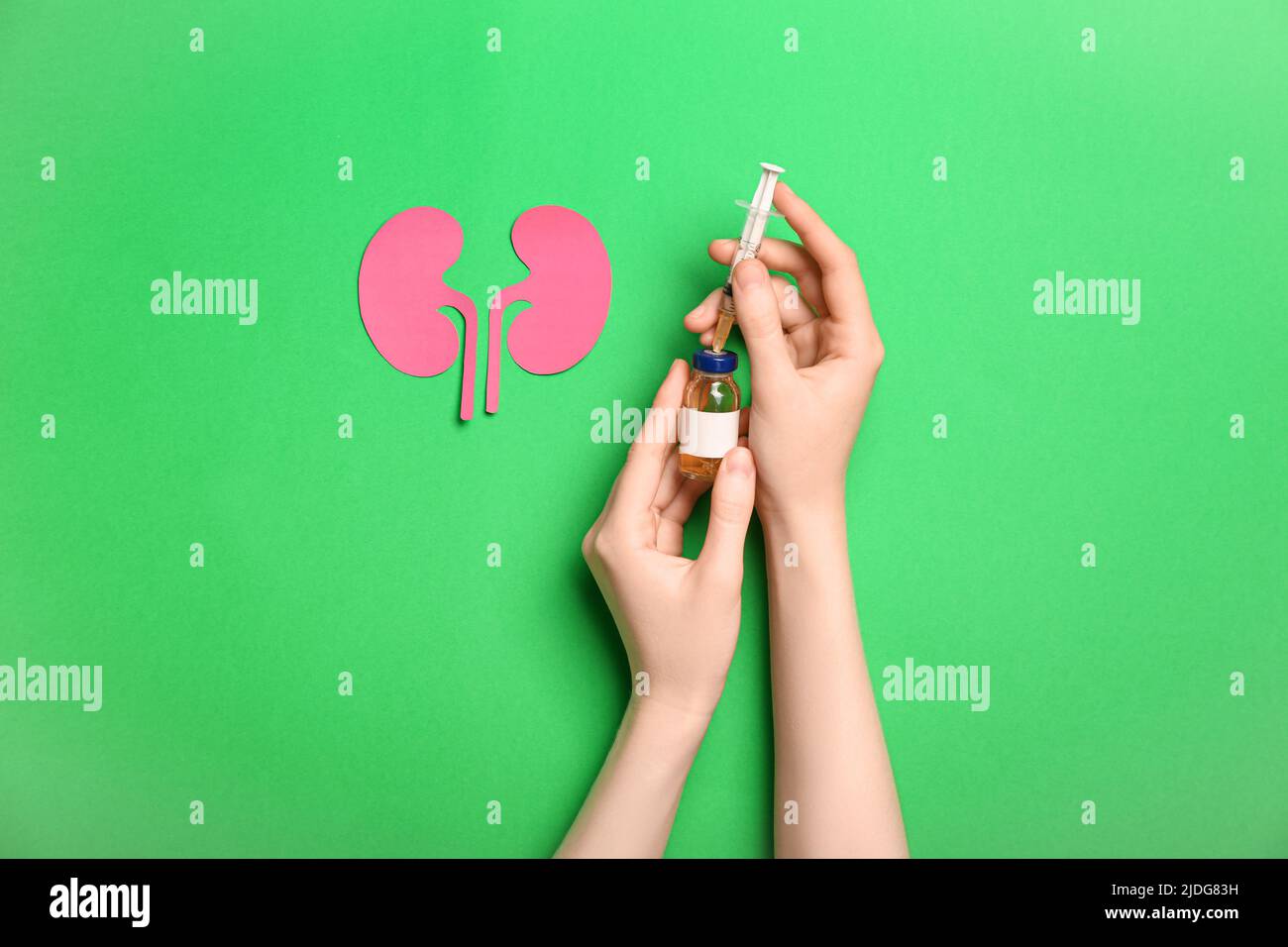 Woman with ampule, syringe and paper kidneys on green background Stock ...