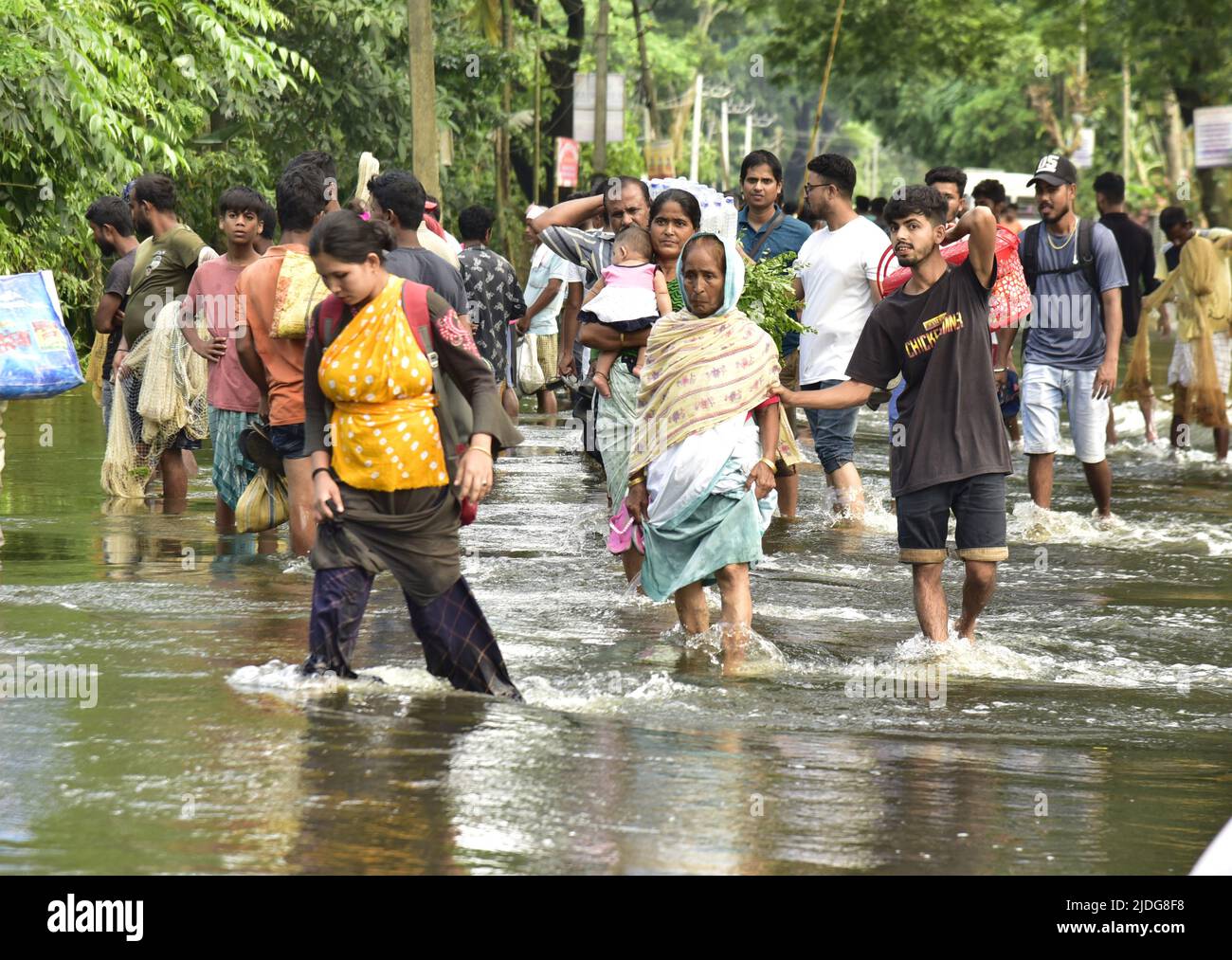 Guwahati, Guwahati, India. 20th June, 2022. Villagers wades through the ...