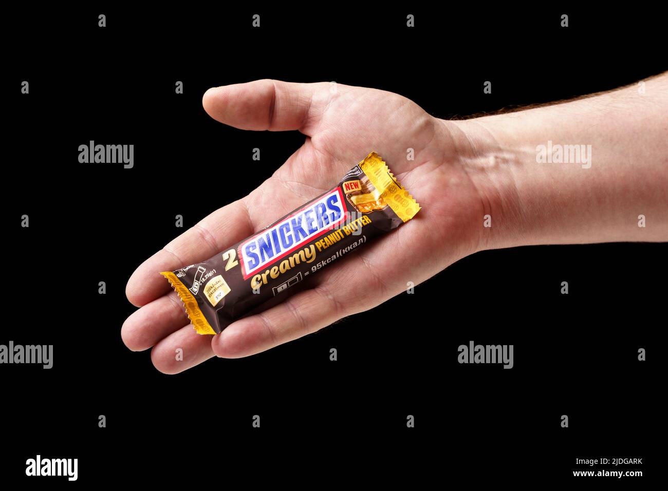 A man offers a Snickers chocolate bar, hand holding a chocolate bar ...