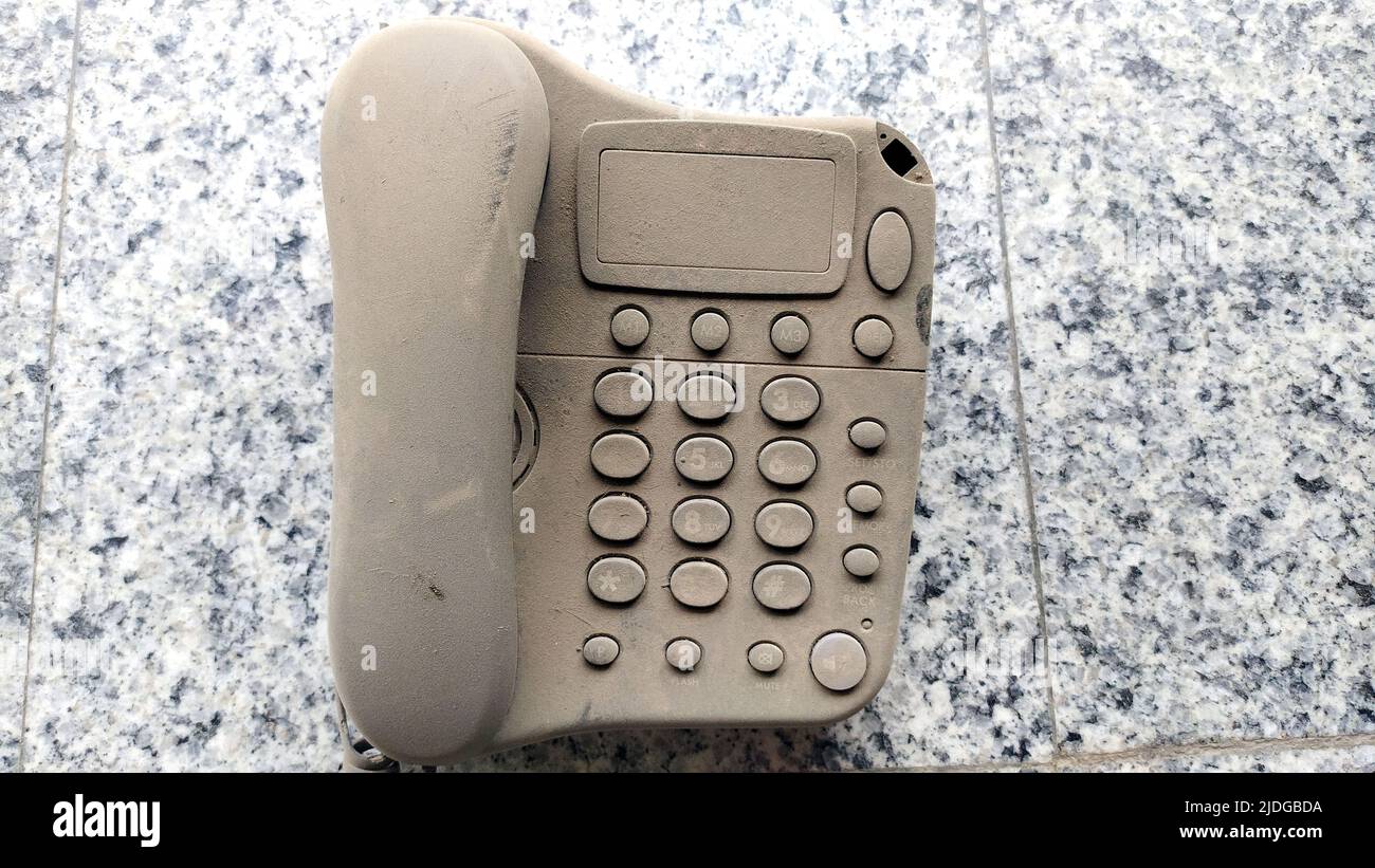 very old telephone with huge dust isolated on stone background Stock ...