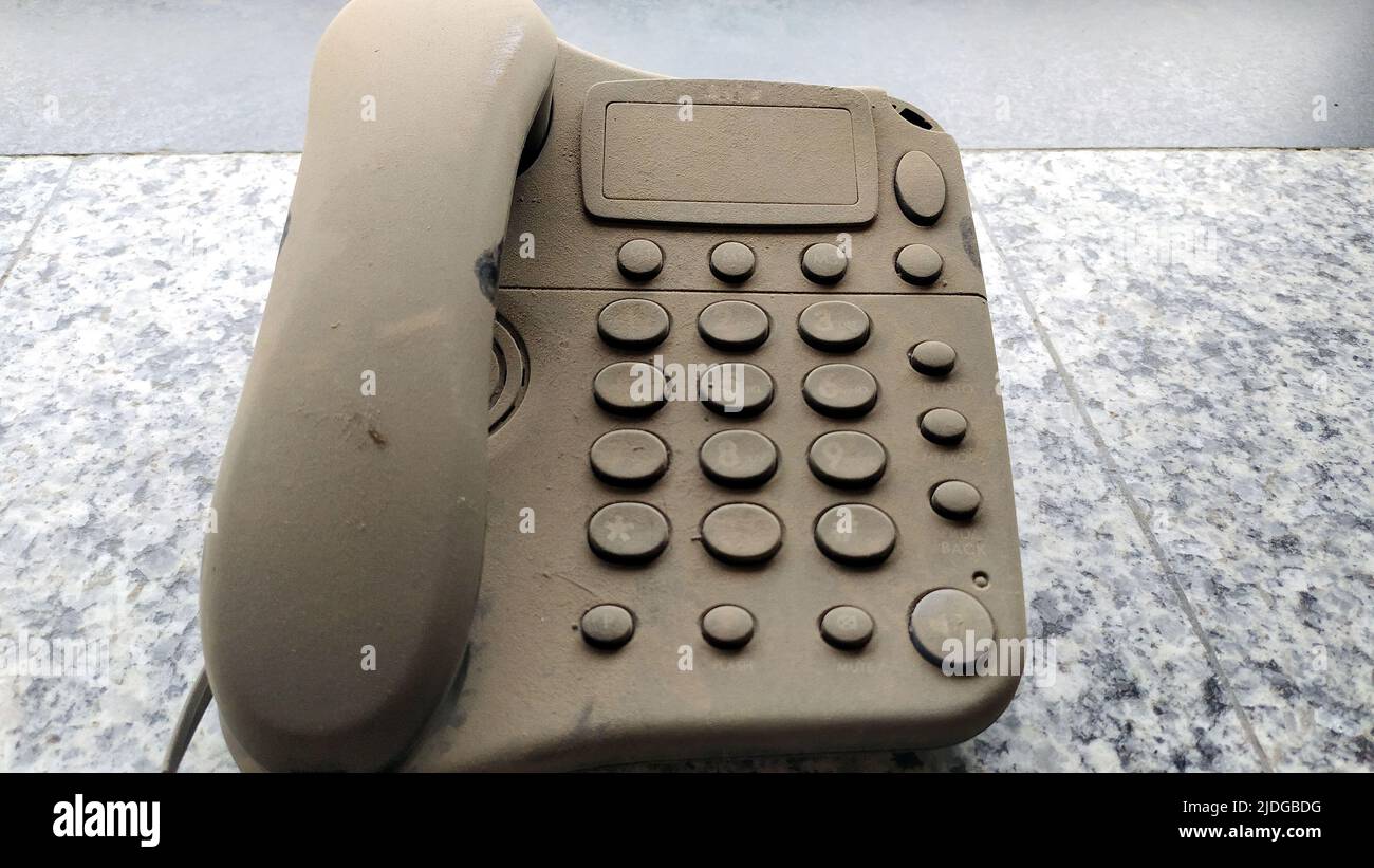 very old telephone with huge dust isolated on stone background Stock ...