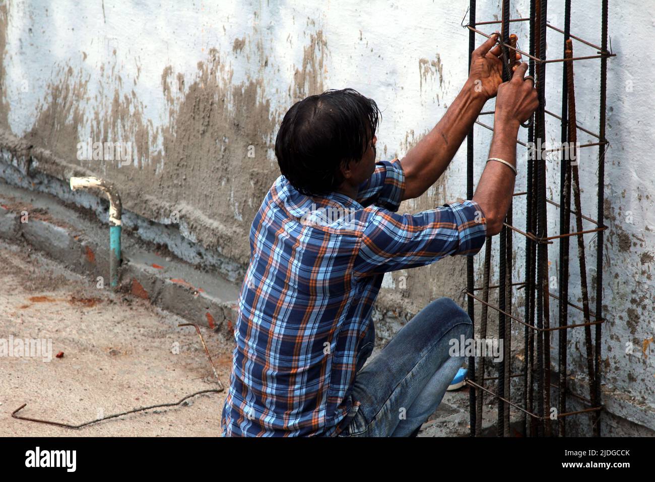 a worker doing work on construction site Stock Photo - Alamy