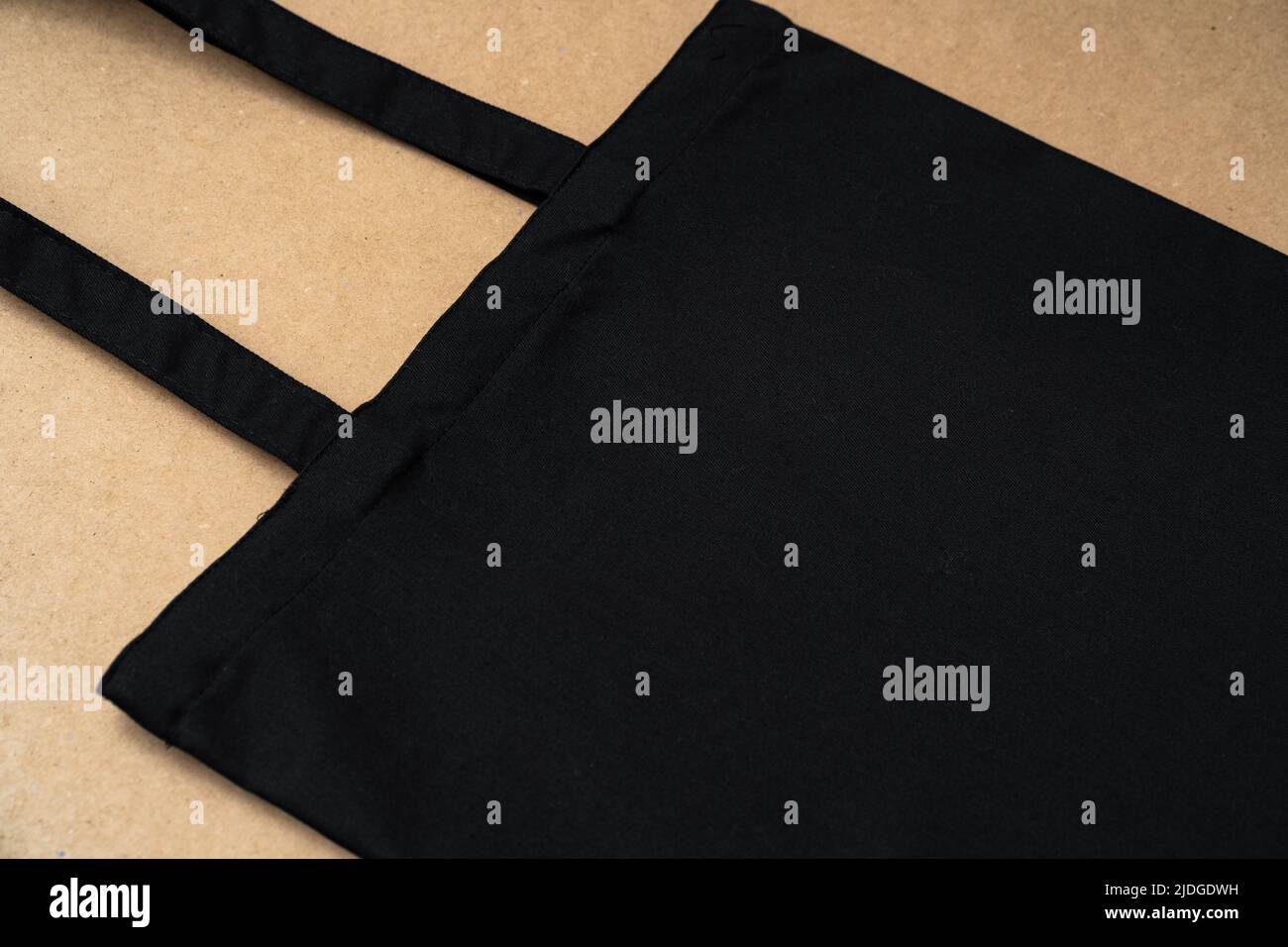 Black textile shopping bag on beige background flat lay Stock Photo - Alamy