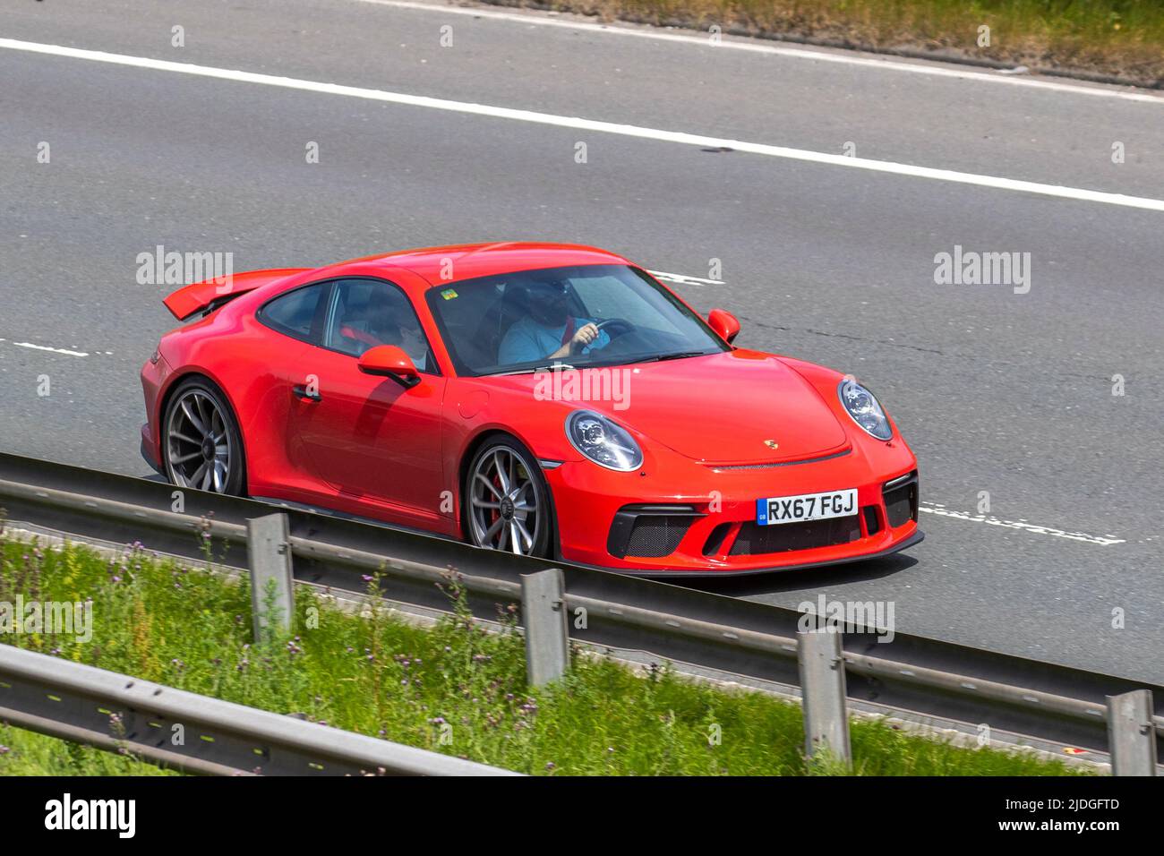 2018 red Porsche 3996cc petrol automatic coupe; driving on the M6 ...