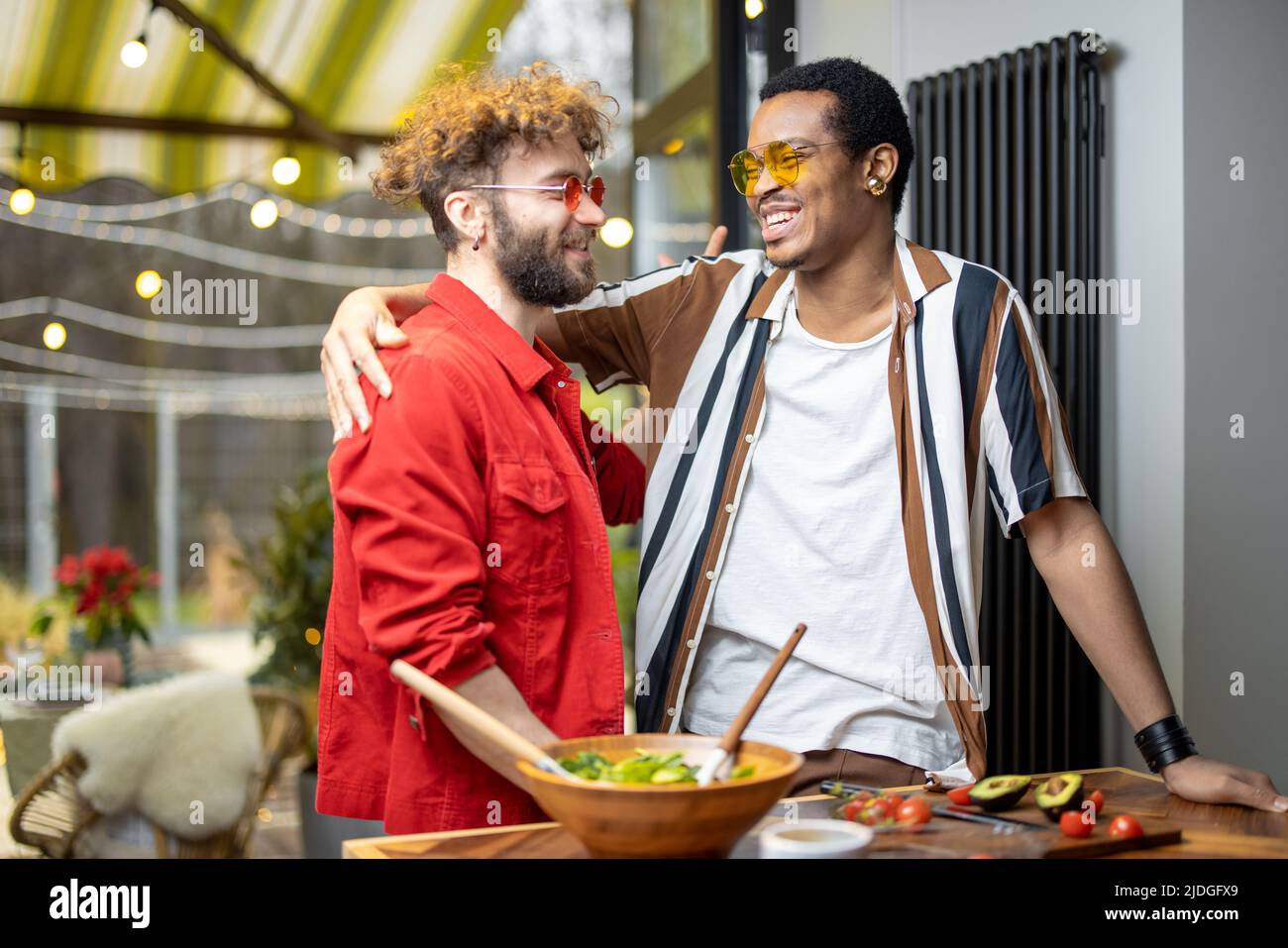 Two cool guys hugging while cooking at home Stock Photo - Alamy
