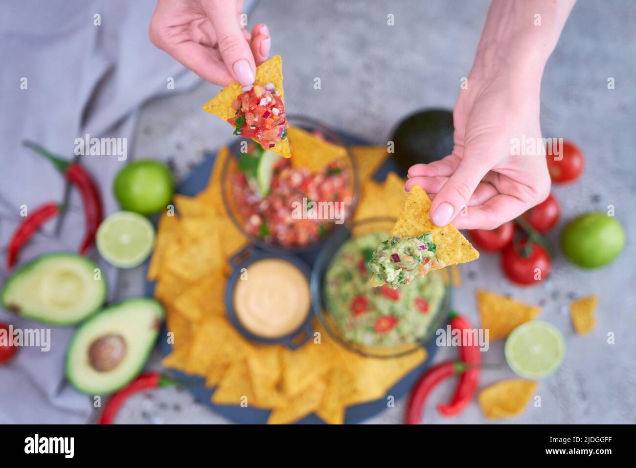 freshly made salsa and guacamole dip sauce with nacho chips on stone ...