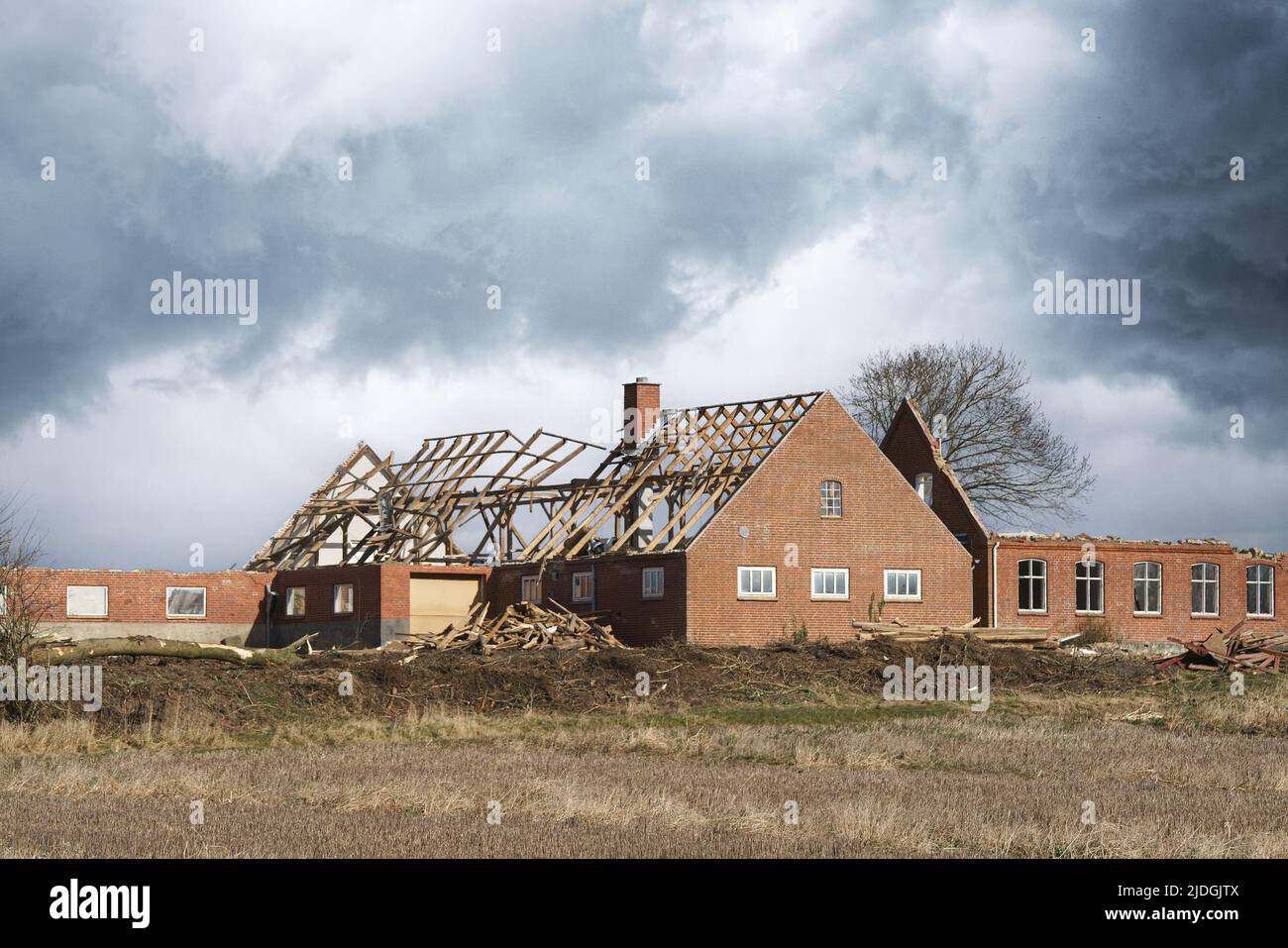 House damaged by a storm with roof destroyed under a cloudy sky Stock ...
