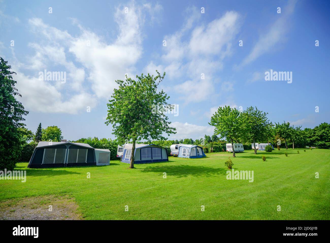Camping site with a tent camp on a large green lawn in the summer Stock ...