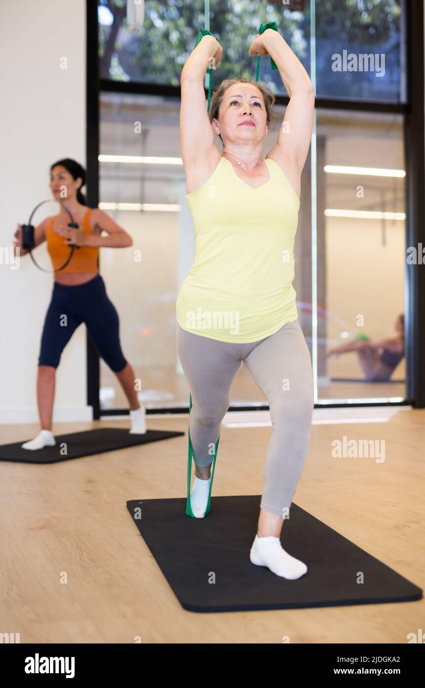 Women doing stretches with resistance bands Stock Photo - Alamy