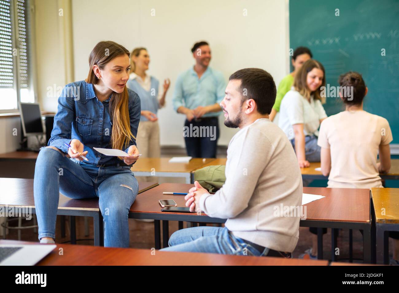 Student listening to friend class hi-res stock photography and images ...