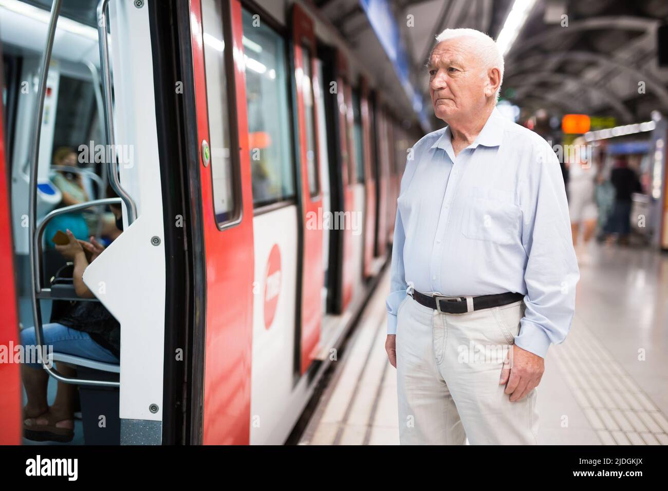 Old man standing in subway station Stock Photo - Alamy