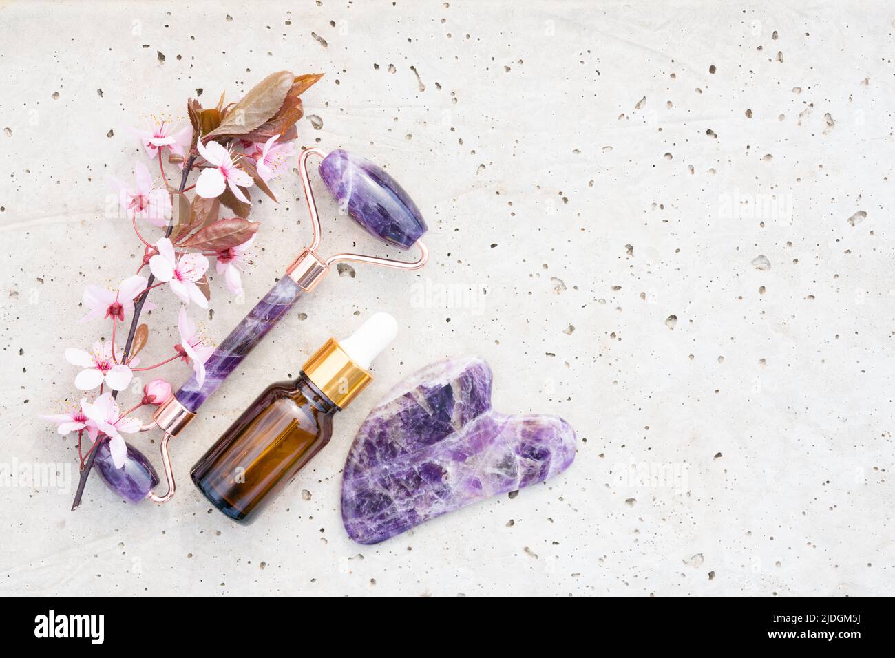 Flat lay composition with facial massage kit - amethyst gua sha tool ...