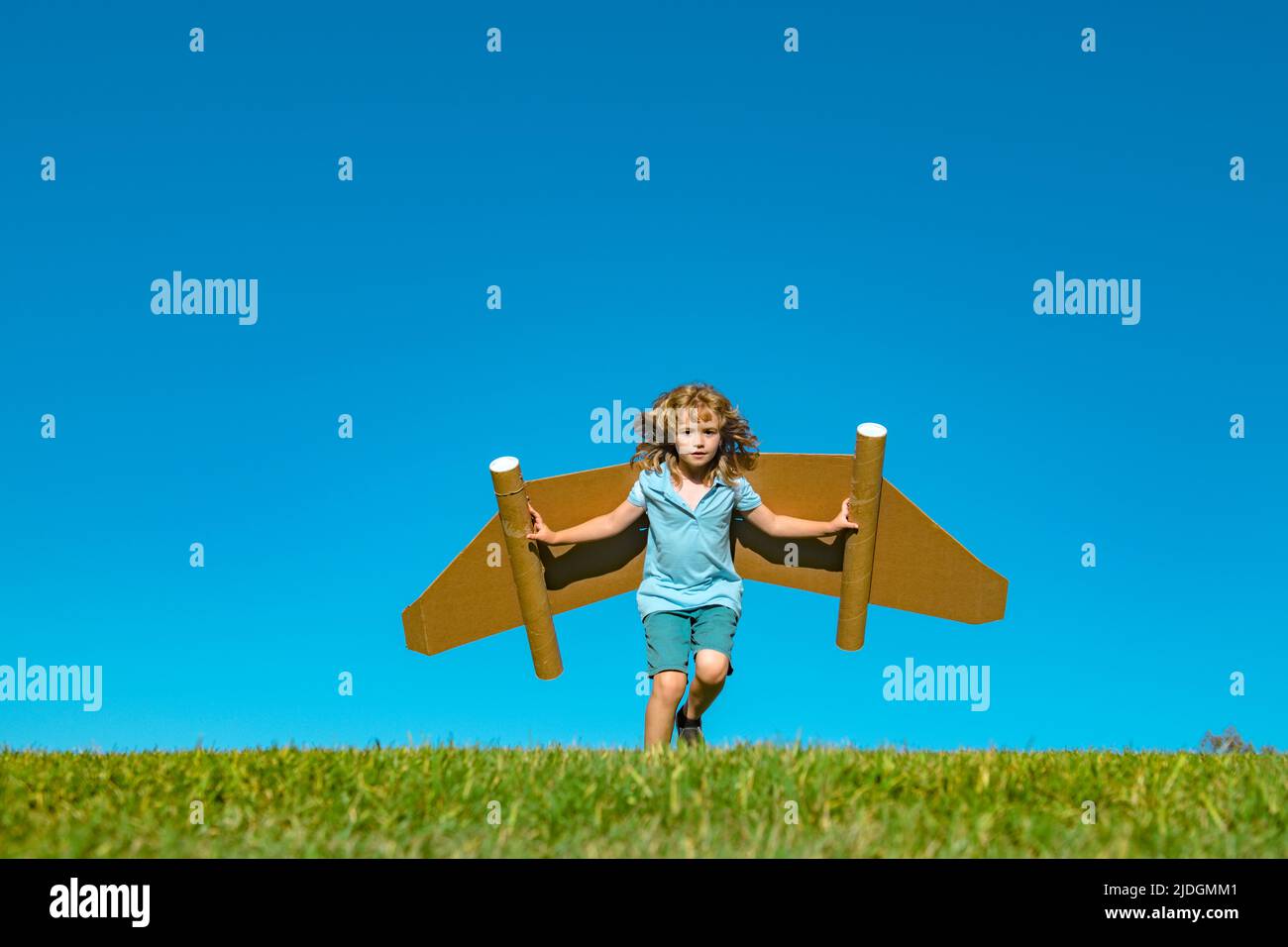 Kid with jet pack superhero. Child pilot against summer sky background ...
