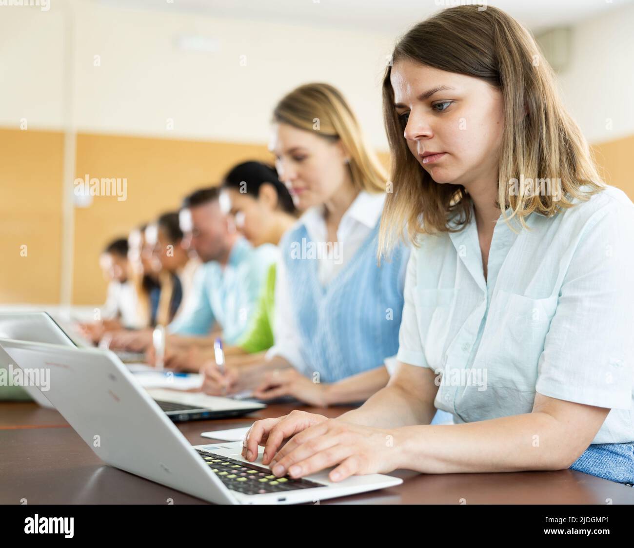 Side view of group of adult students in university classroom Stock ...