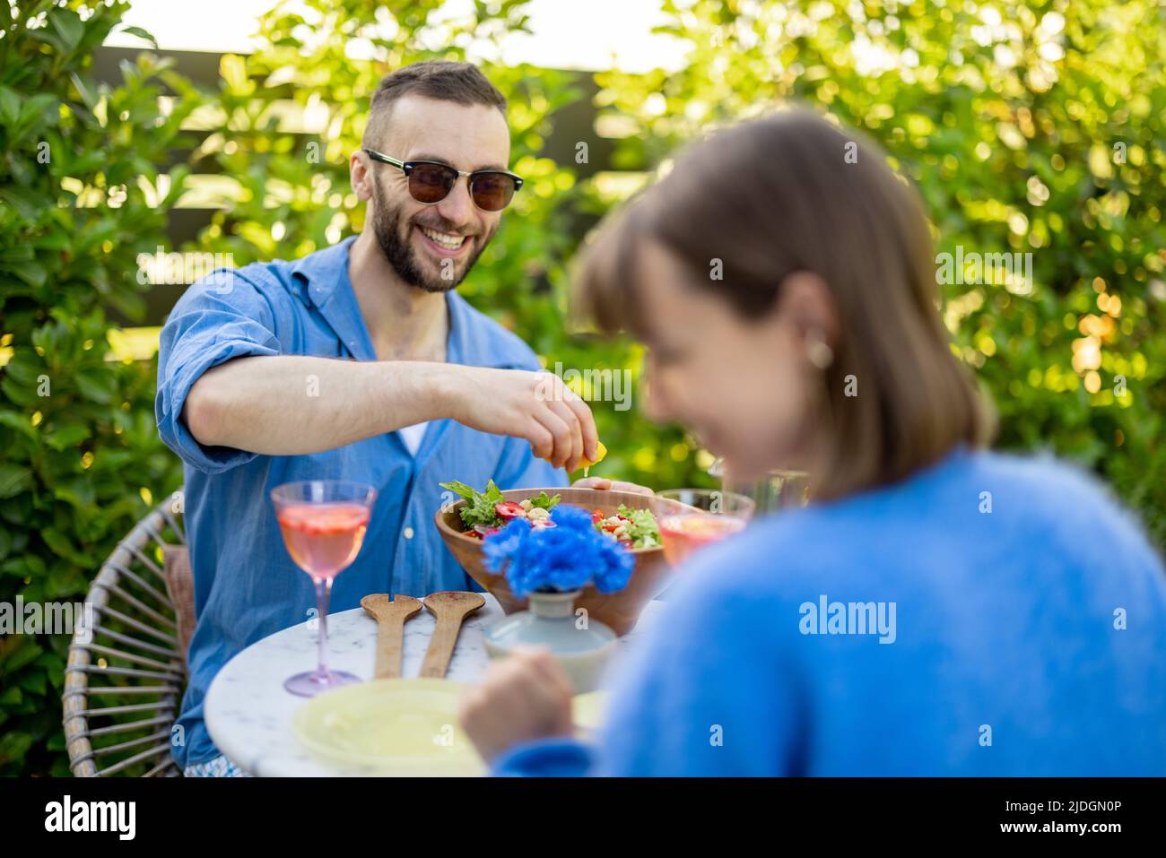 Young family having healthy lunch at backyard Stock Photo - Alamy