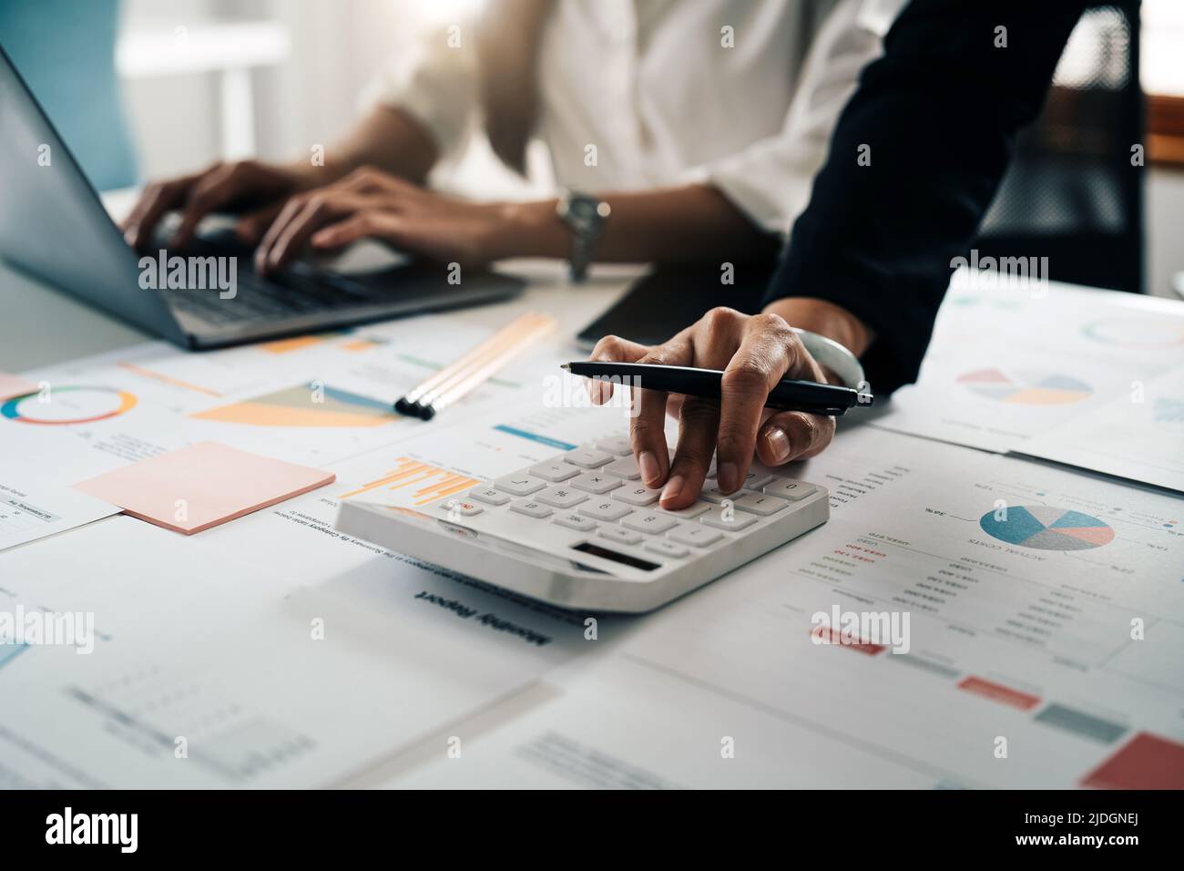 business people meeting with pen pointing paper financial graph ...