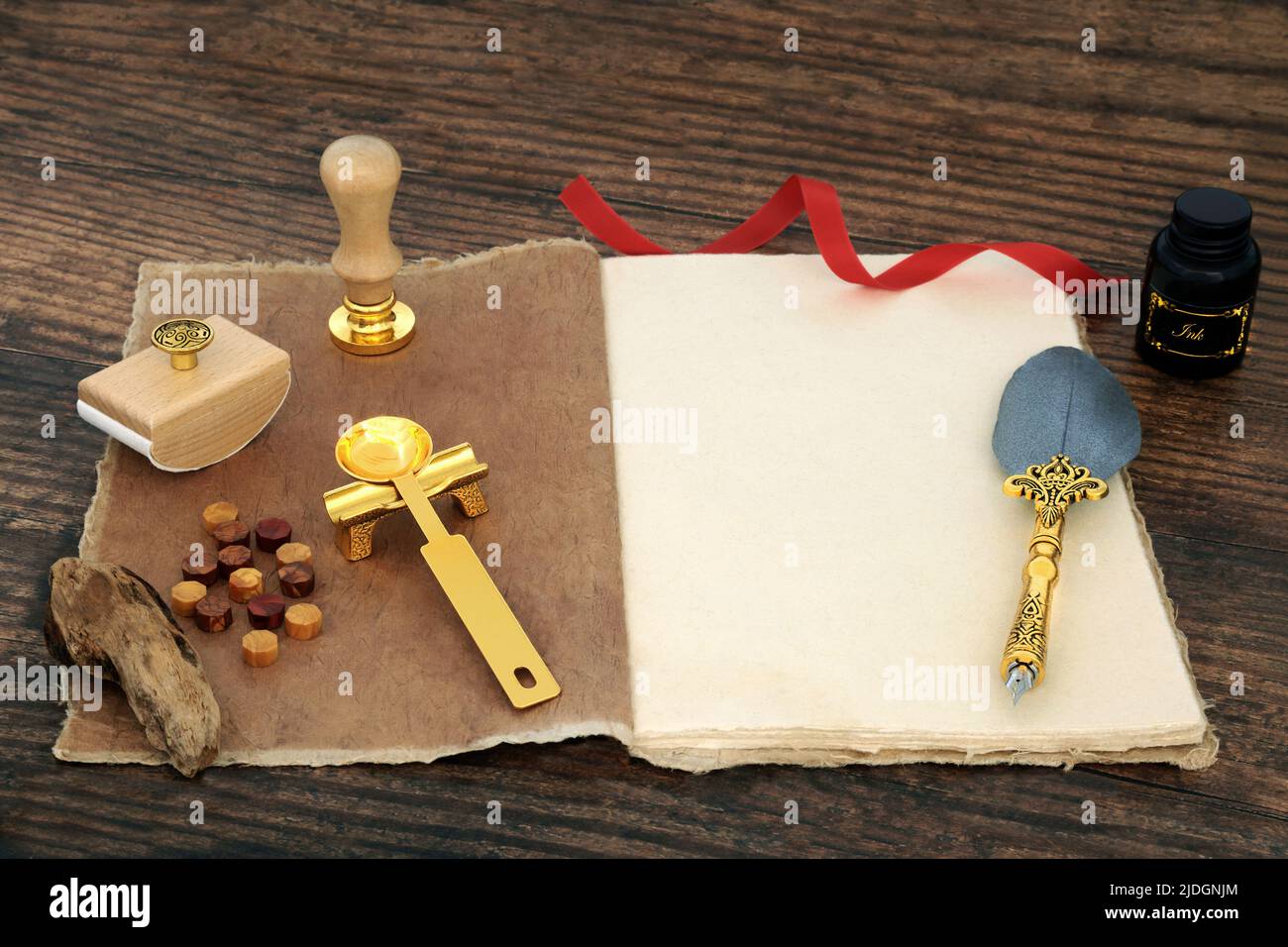 Old fashioned retro writing equipment with hemp notebook, quill feather ...