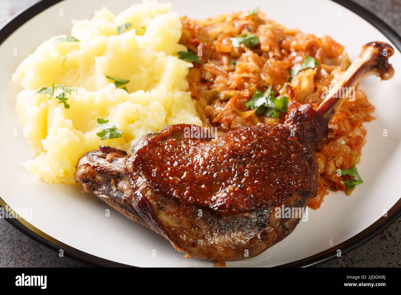 Delicious roasted goose leg with stewed cabbage and mashed potatoes ...