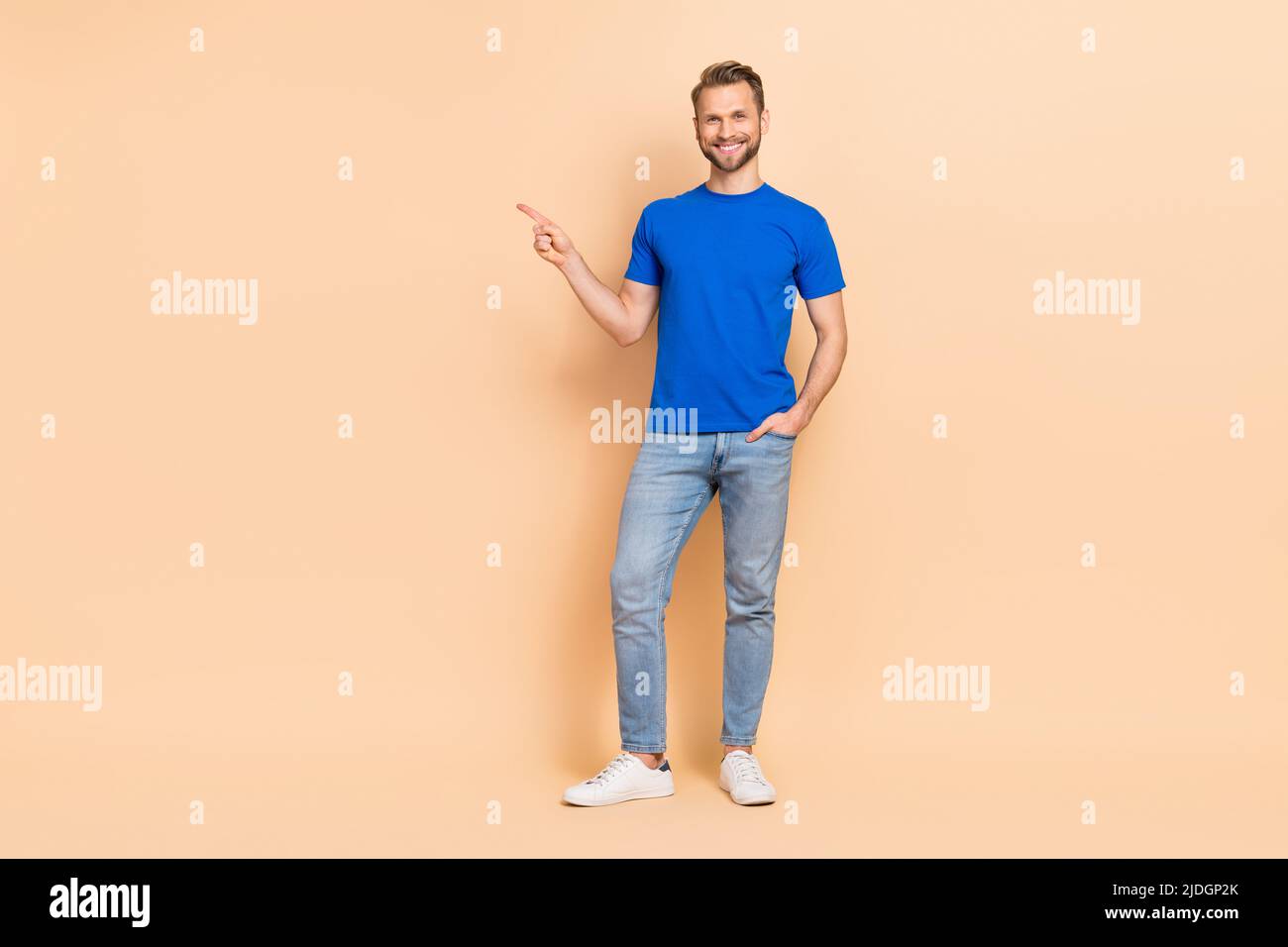 Full length photo of young guy indicate finger empty space suggest ...