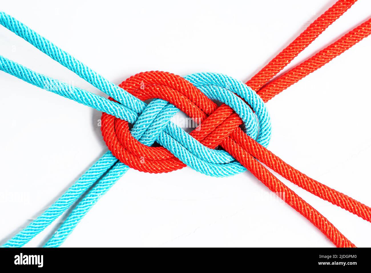 Red and blue braided cords tied together in the shape of an infinity ...