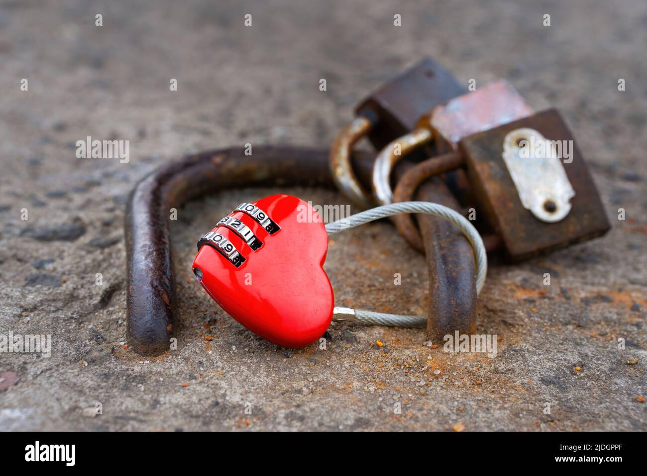 Freshly locked red heart shaped combination wire rope lock close to ...