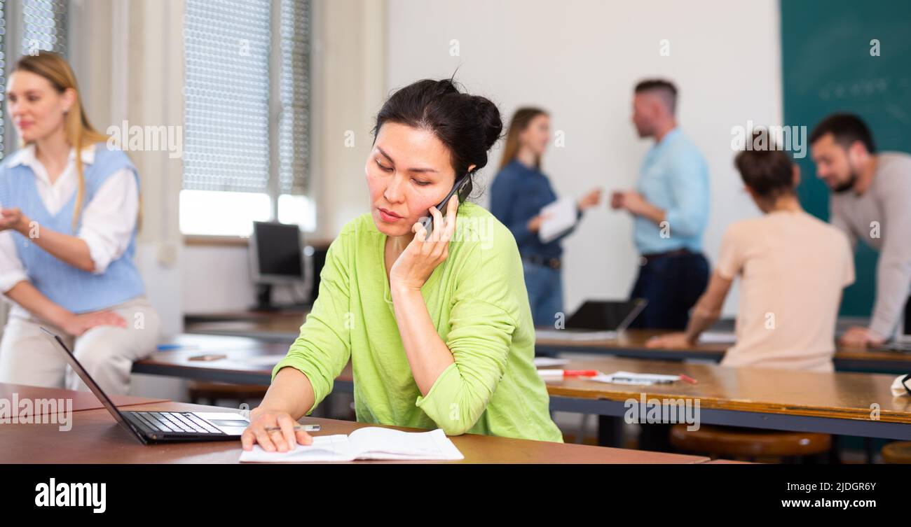 Woman university student talking on phone during recess Stock Photo - Alamy