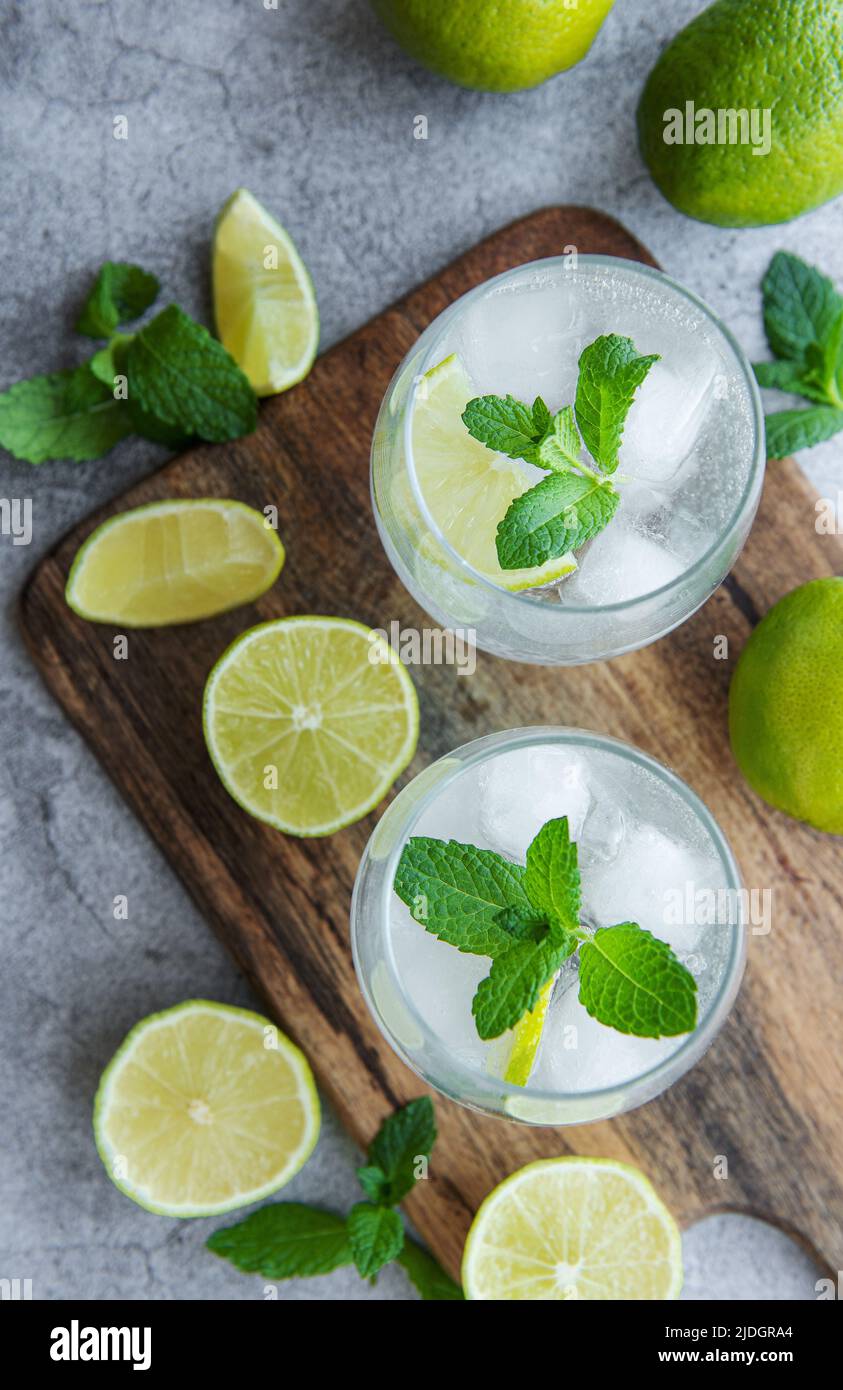 Iced cold lemonade with fresh lime and juice. Summer drink in glasses ...