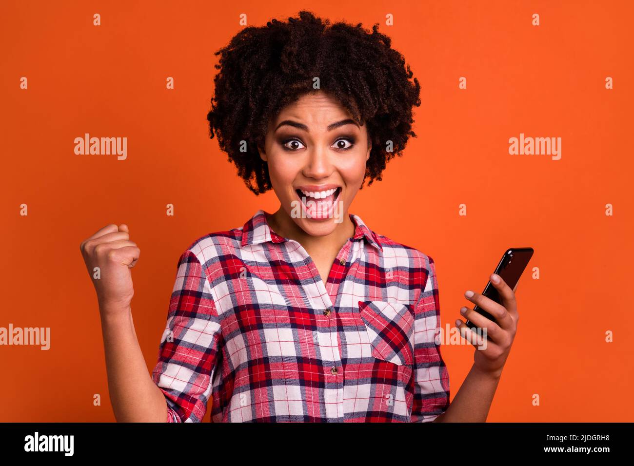 Portrait of delighted person raise fist celebrate follow hold phone ...