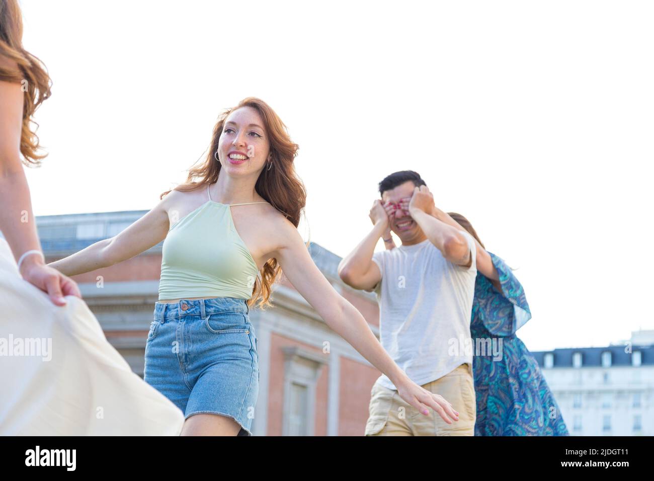 Group of multiethnic friends joking while walking in line in a fun way ...
