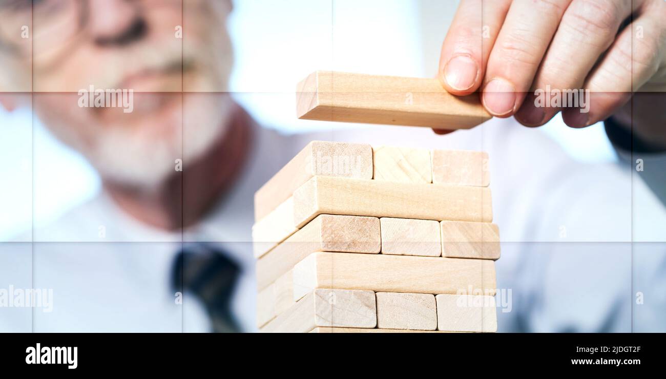 Business development concept by building a tower with domino blocks ...