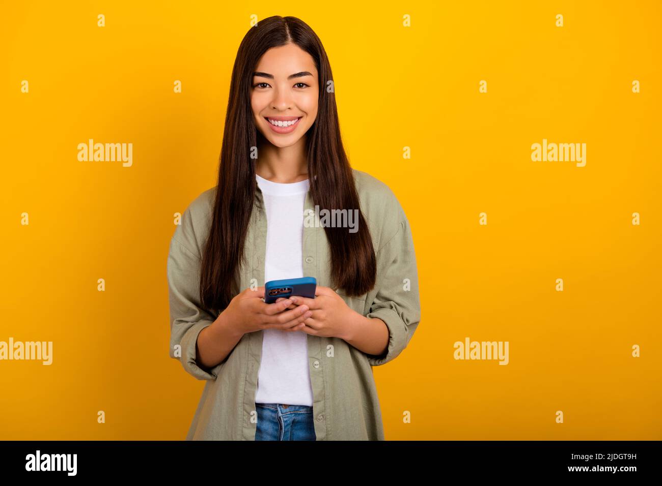 Photo of adorable good mood girl surfing in social media go through her ...