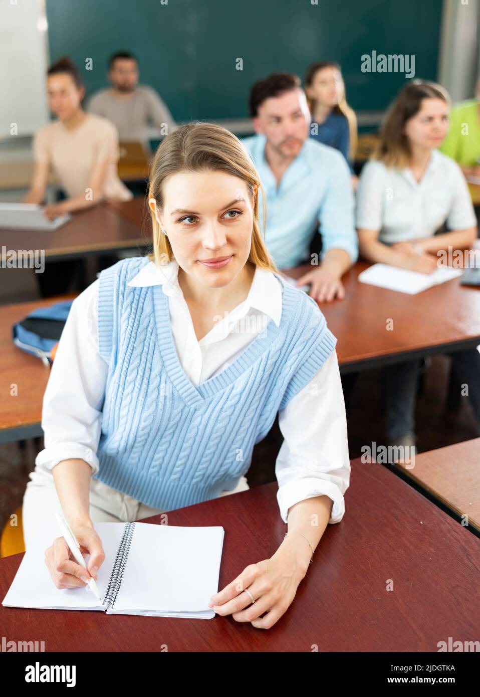 Portrait of a girl student writing a lecture synopsis Stock Photo - Alamy