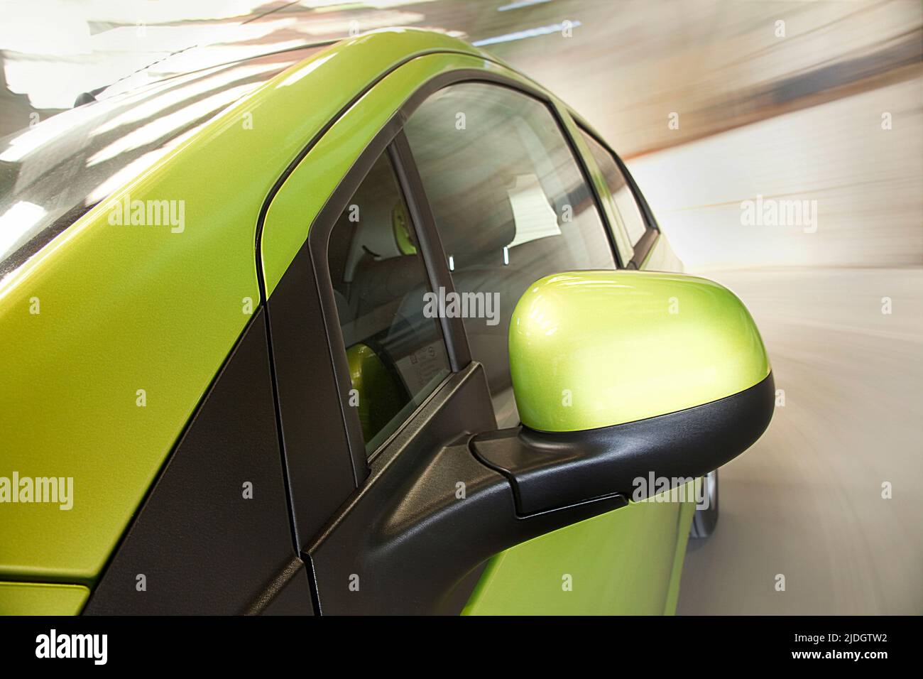 Detail of a car going around a corner in a built environment, creating ...