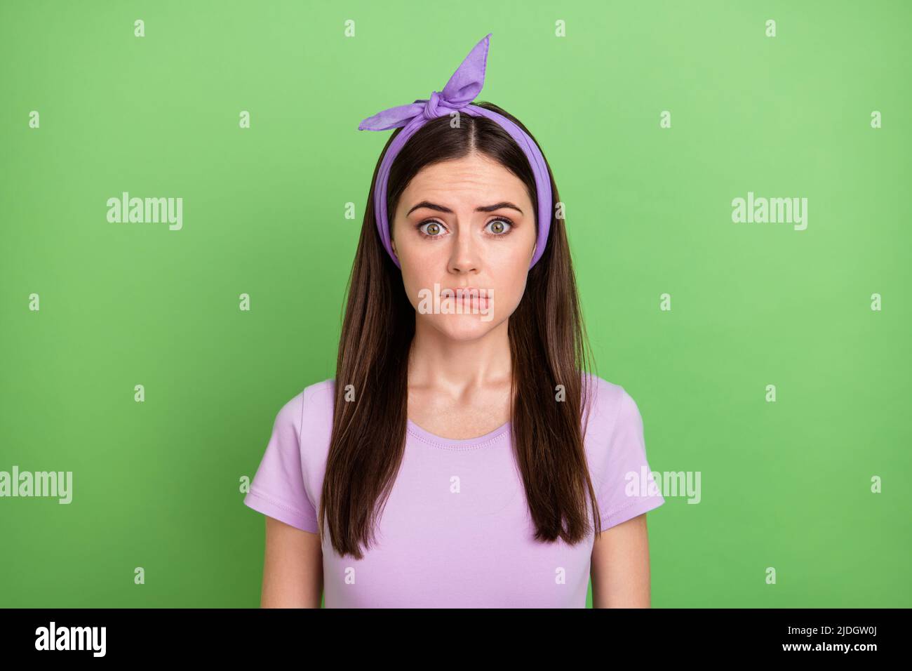 Photo of scared nervous lady dressed purple t-shirt hairband biting lip ...