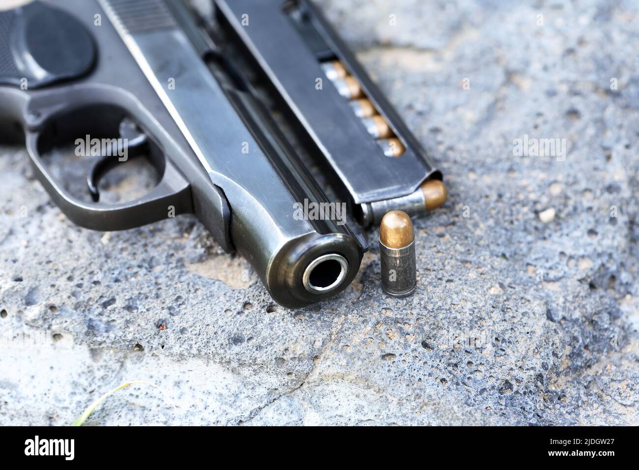 Eight-capacity magazine near handgun on gray stone background Stock ...