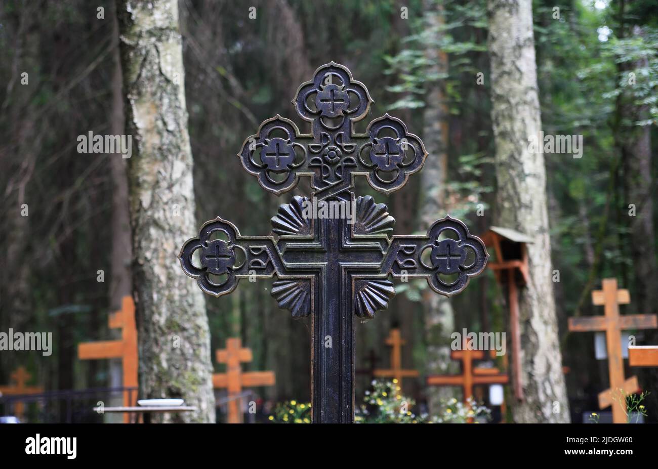 Black metal cross closeup on background with orthodox cemetery Stock ...