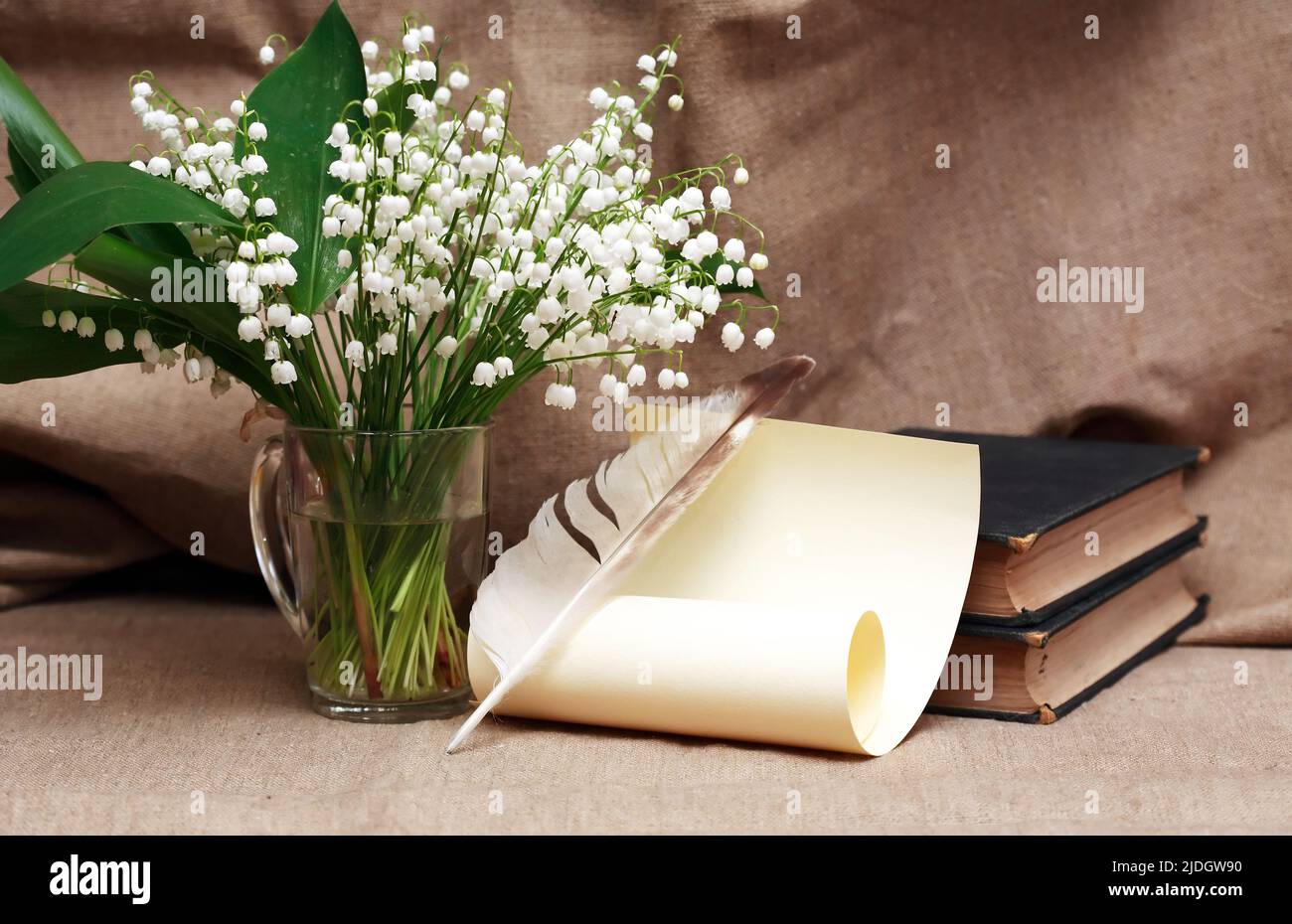 Still life with open book and quill pen near posy of white lilies Stock ...
